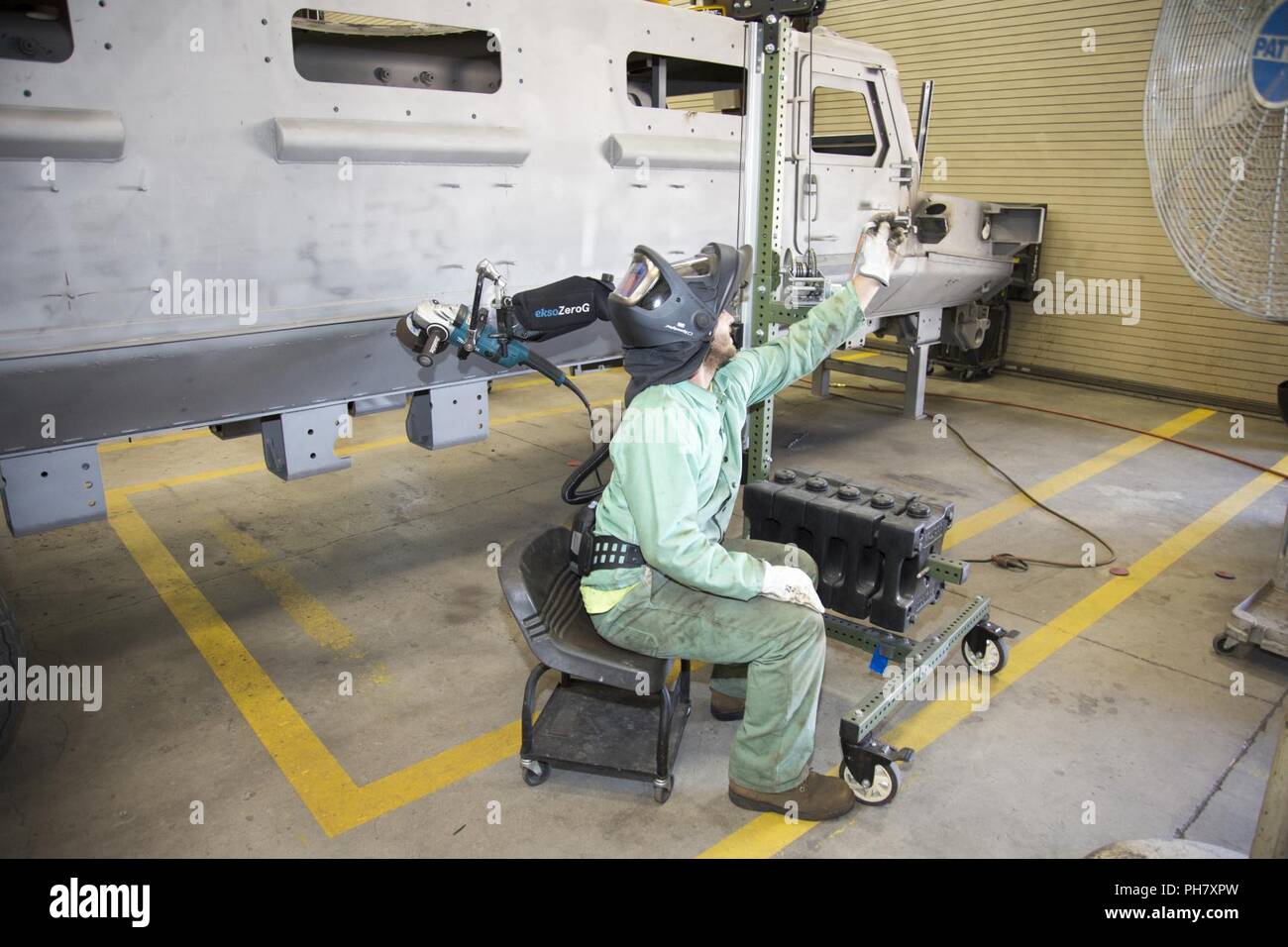 Niels Woods, welder, makes adjustments to the Ekso Zero Gravity arm ...