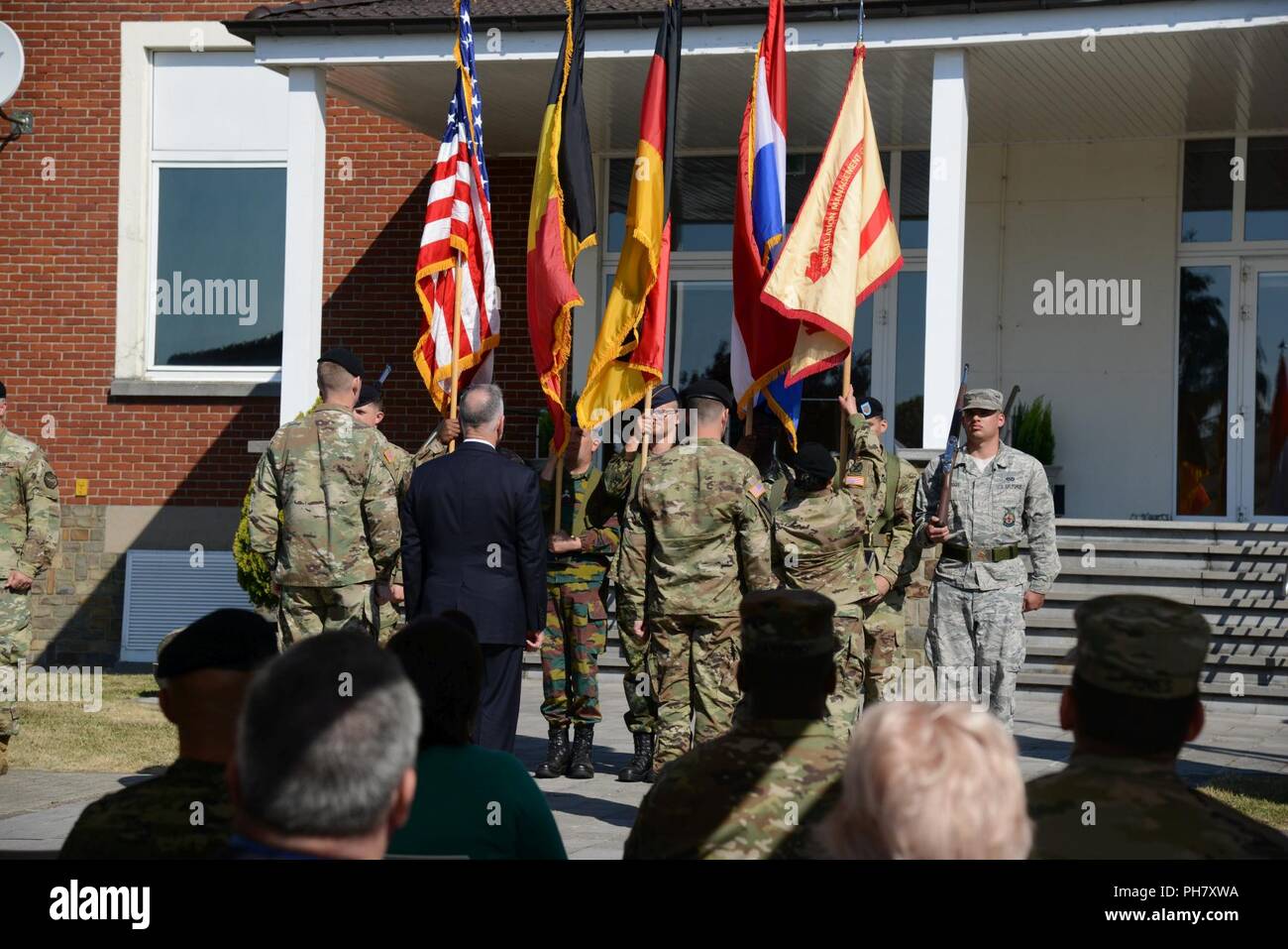 U.S. Army Command Sgt. Maj. Samara L. Pitre receives the colors from ...