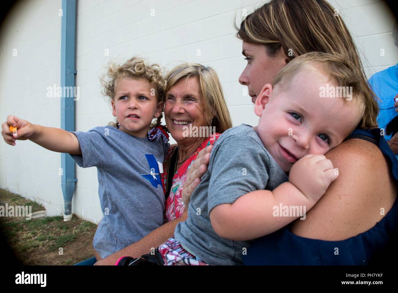 Family members look on as they prepare for their service members ...