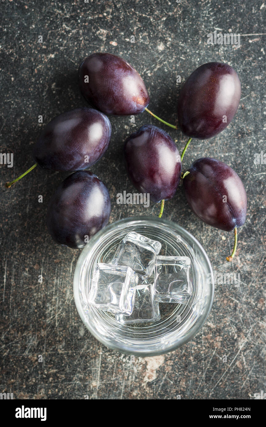 Plum brandy and plums. Tasty slivovitz Stock Photo - Alamy