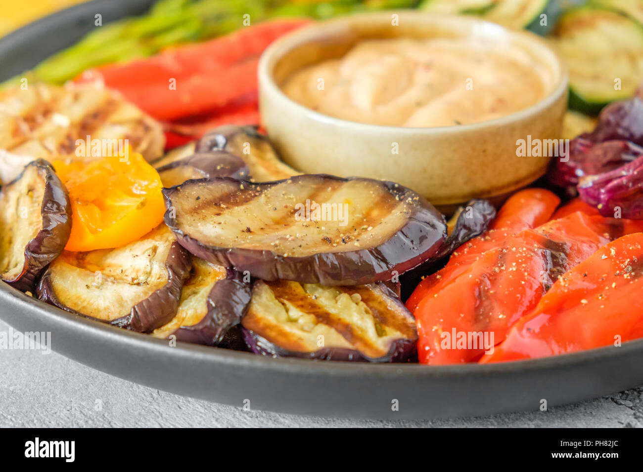 Grilled vegetables on a plate with sauce, selective focus Stock Photo ...