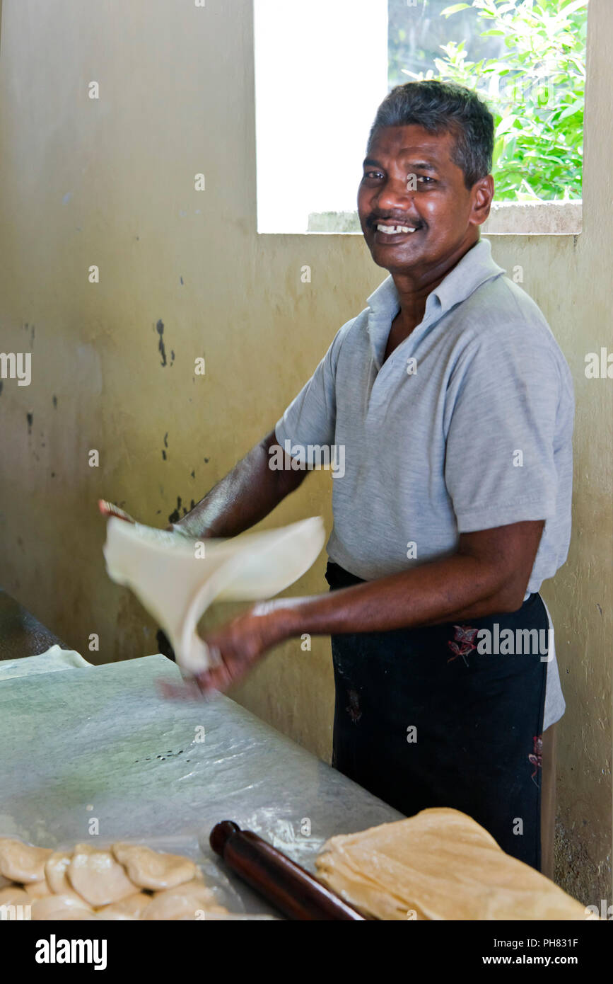 Vertical portrait of a man making traditional unleavened bread in Sri ...
