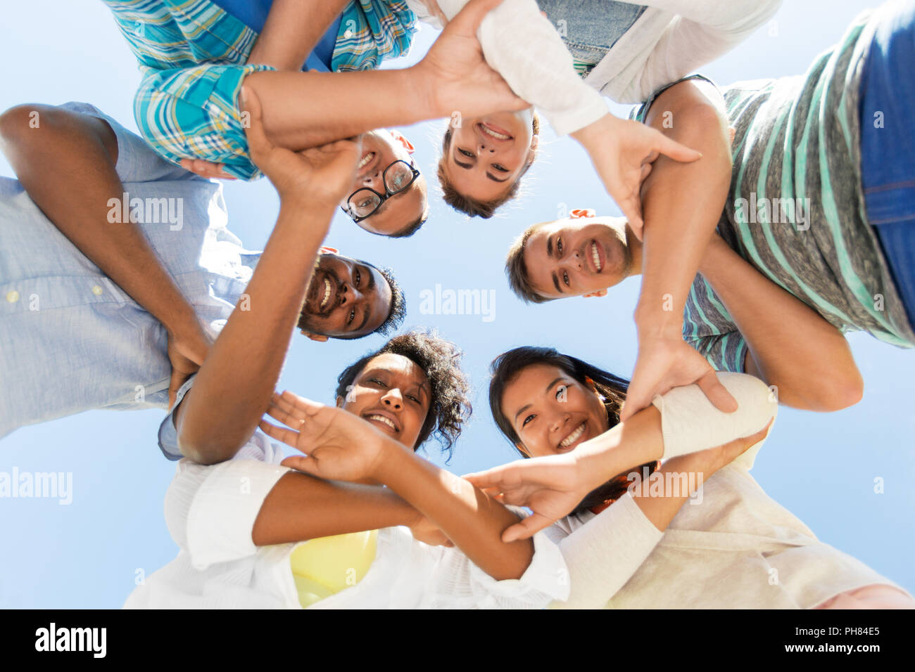 happy smiling friends outdoors standing in circle Stock Photo - Alamy