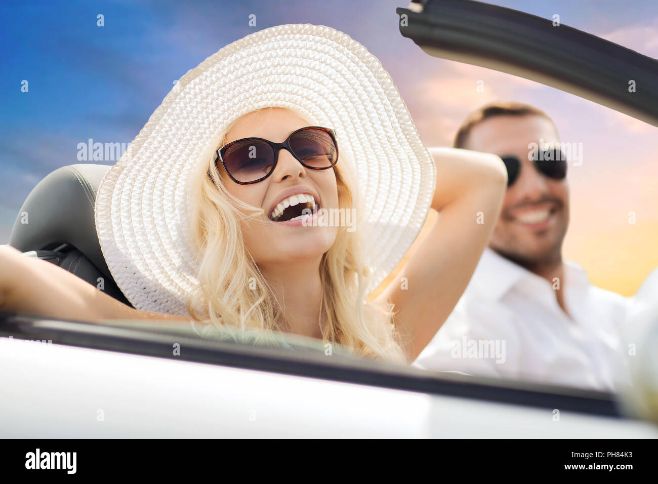 happy couple driving in convertible car over sky Stock Photo - Alamy
