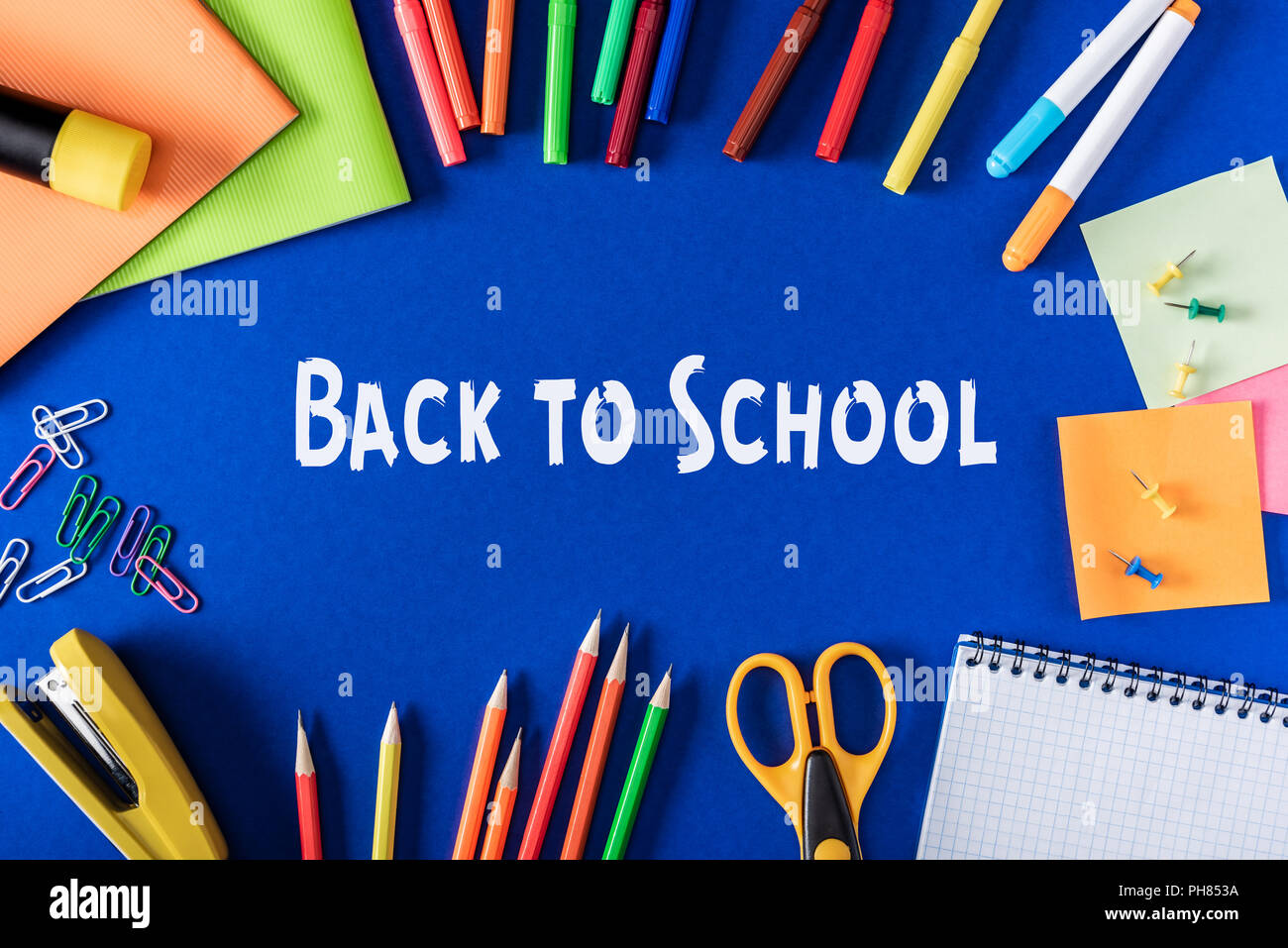 top view of lettering back to school from white paper surrounded by ...