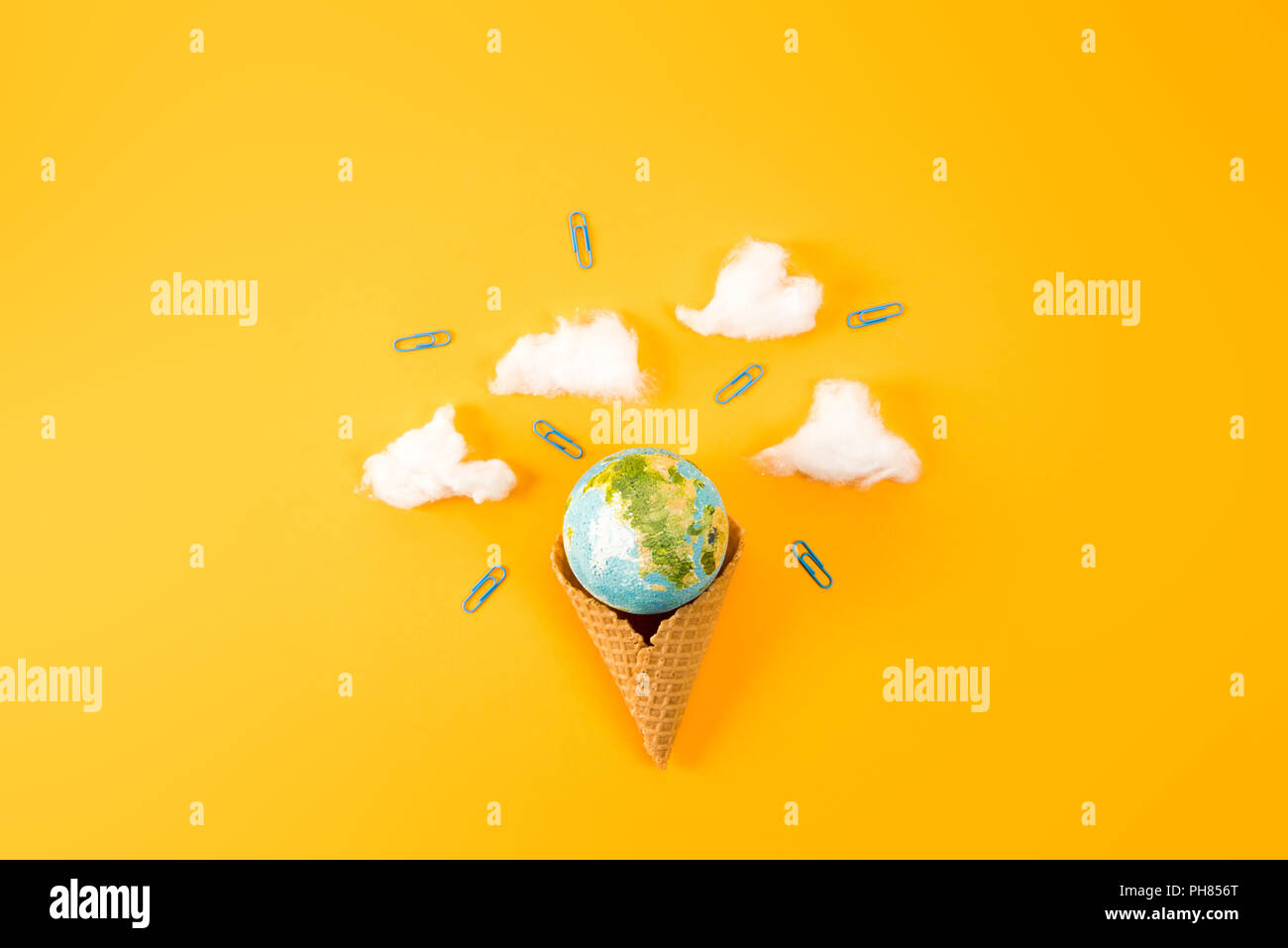 top view of earth globe in waffle cone with clouds made of cotton on ...