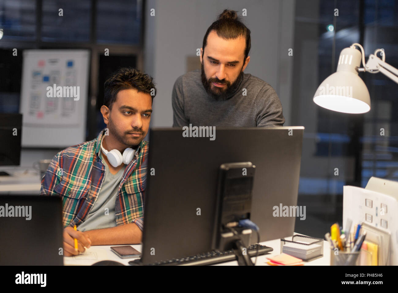 creative team with computer working late at office Stock Photo - Alamy