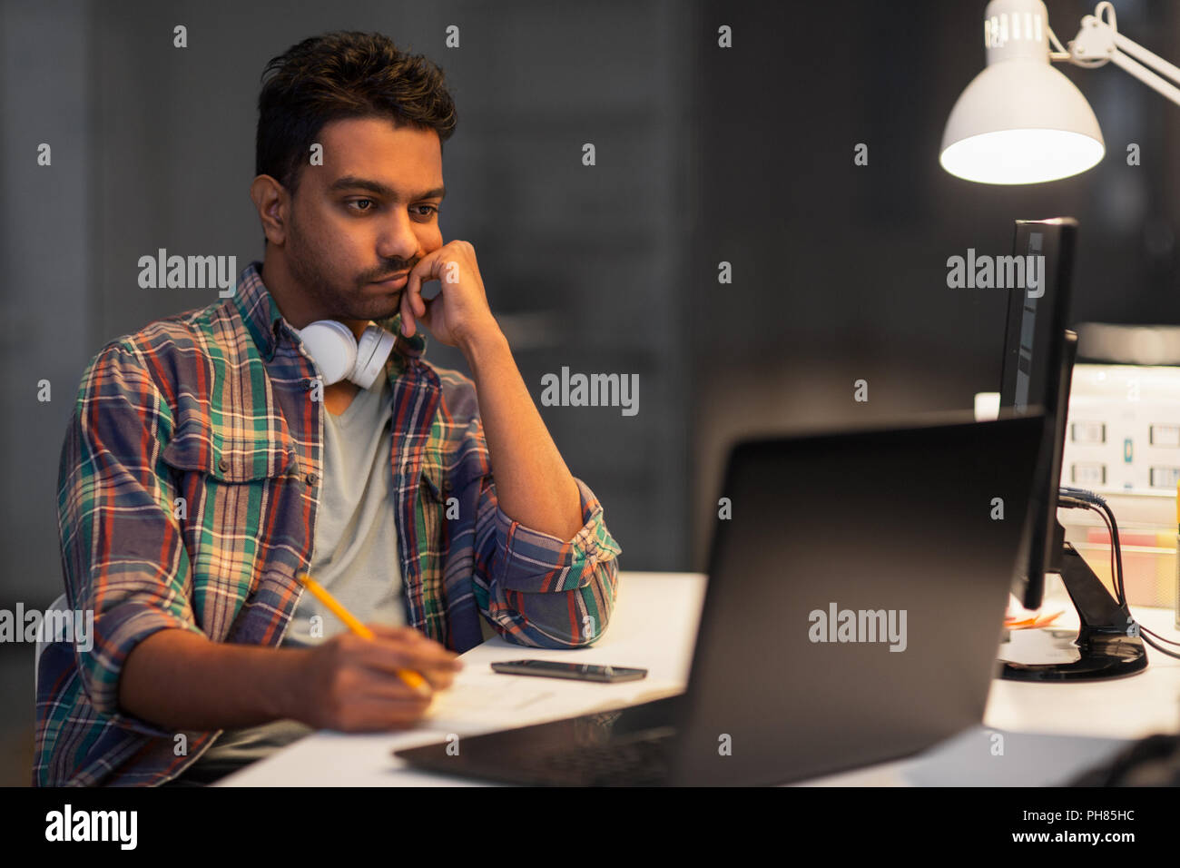 Pensive young creative man writing hi-res stock photography and images ...