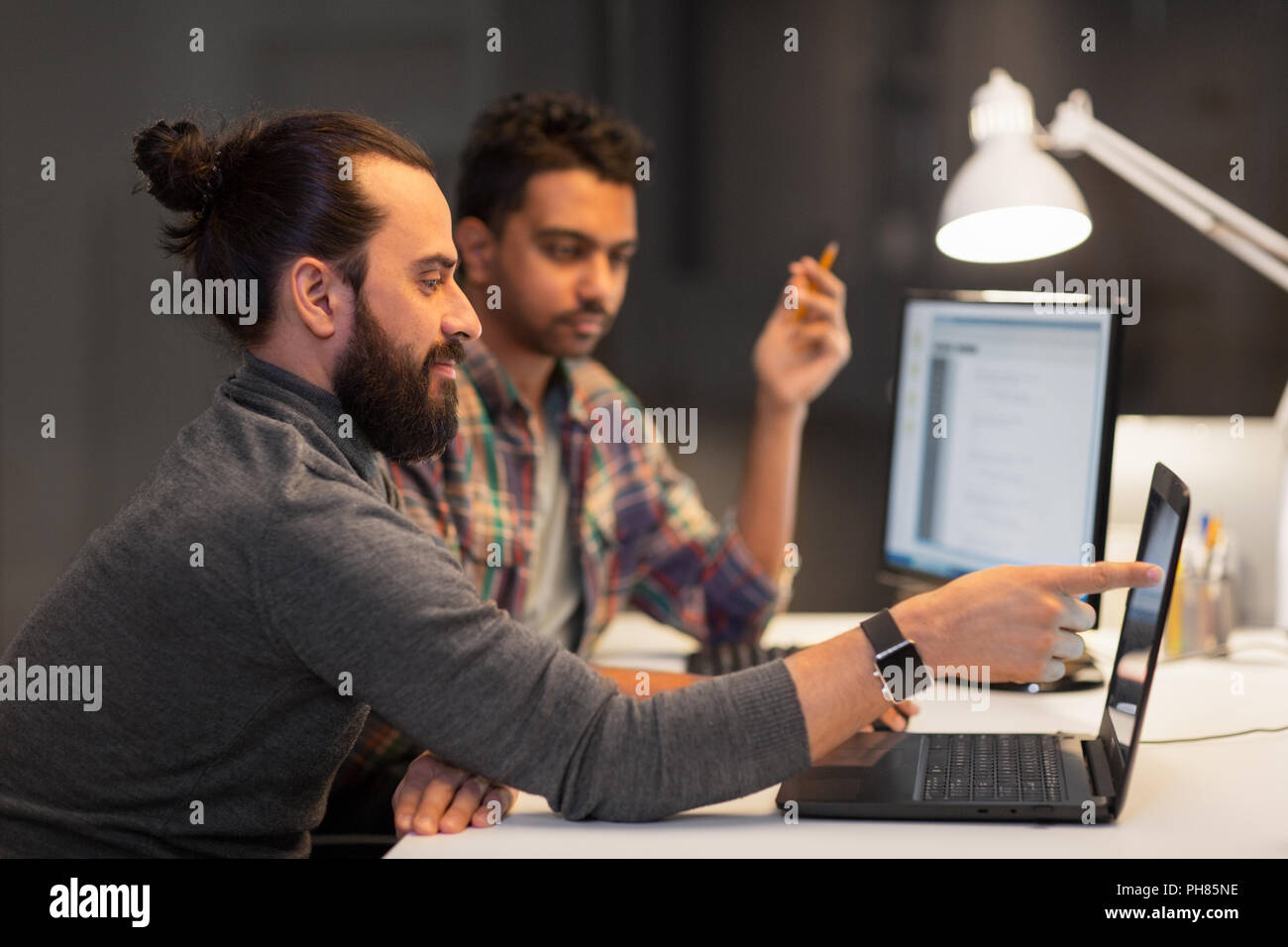 creative team with computer working late at office Stock Photo - Alamy