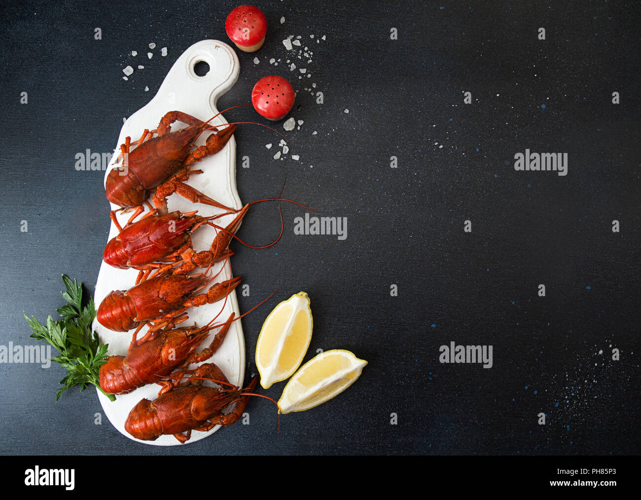 Boiled cooked crayfish crawfish ready to eat on white cutting board ...