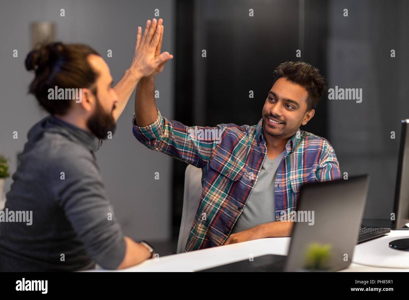 creative team making high five at night office Stock Photo - Alamy