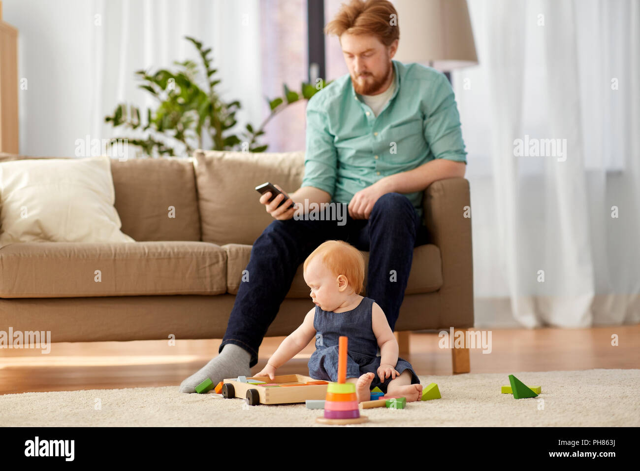 Father and infant playing with toy hi-res stock photography and images ...
