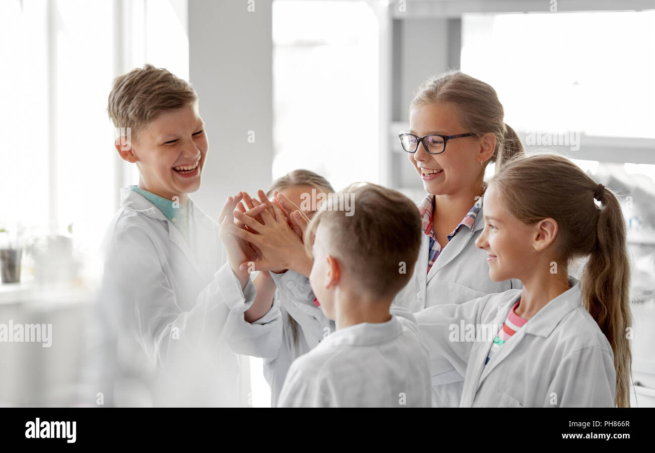happy kids making high five at school laboratory Stock Photo - Alamy