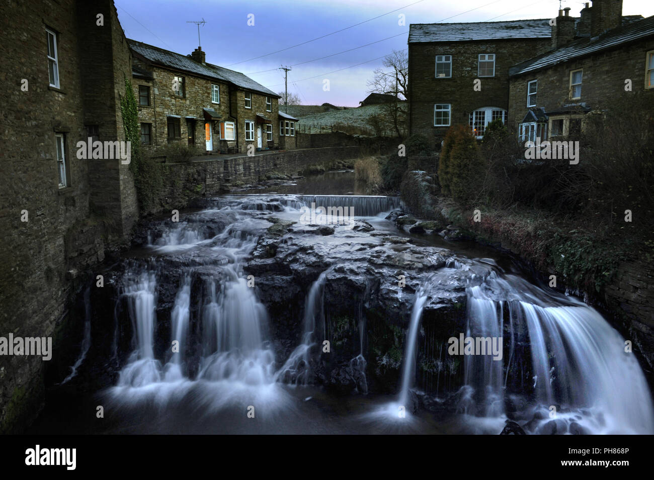 Evening descends on the houses beside Gayle Beck running though the ...