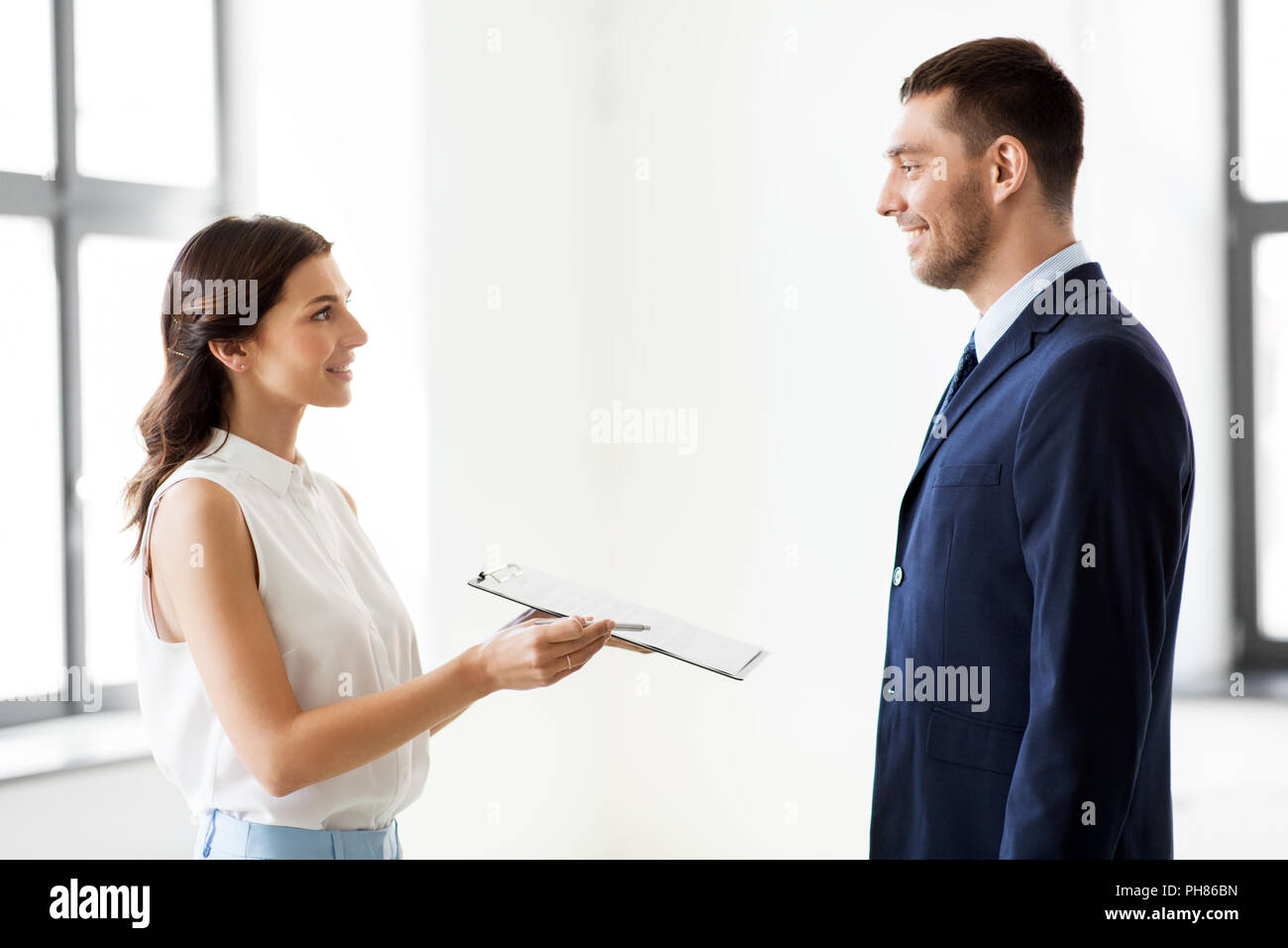 realtor showing contract document to customer Stock Photo - Alamy