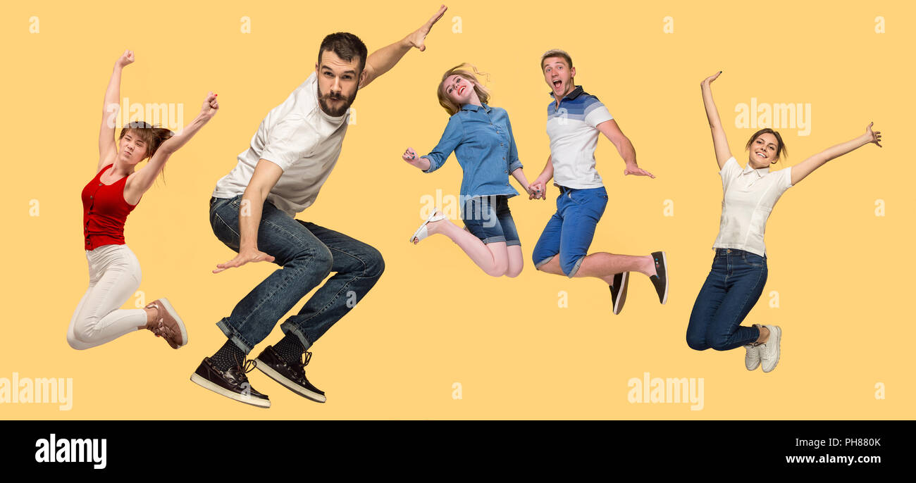 Freedom in moving. Mid-air shot of pretty happy young man and women ...