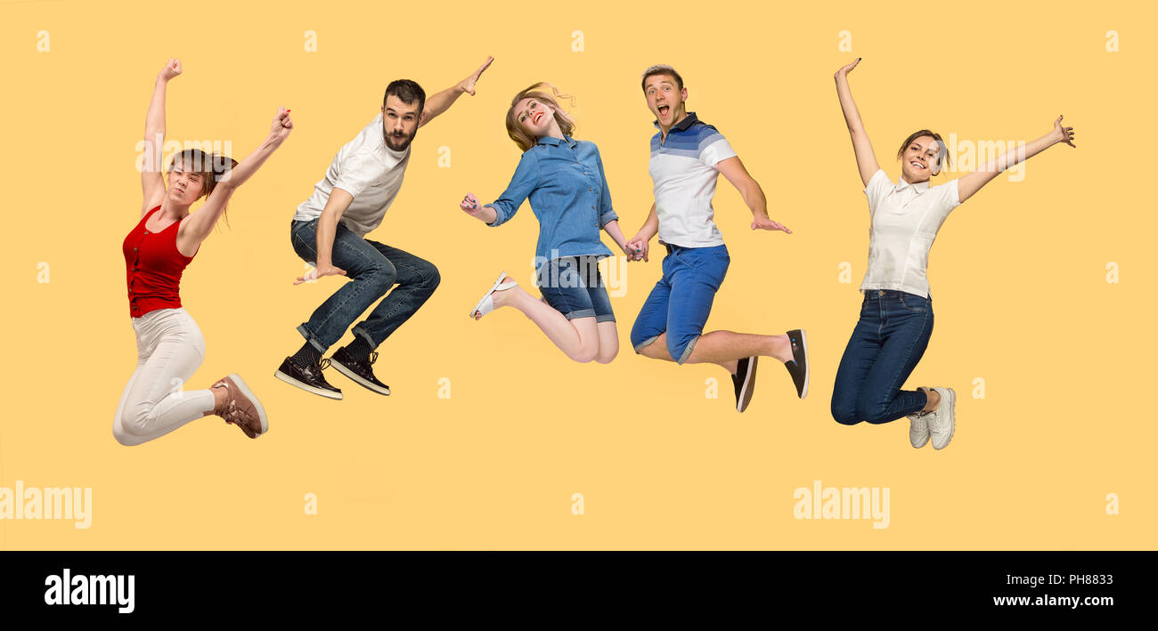 Freedom in moving. Mid-air shot of pretty happy young man and women ...