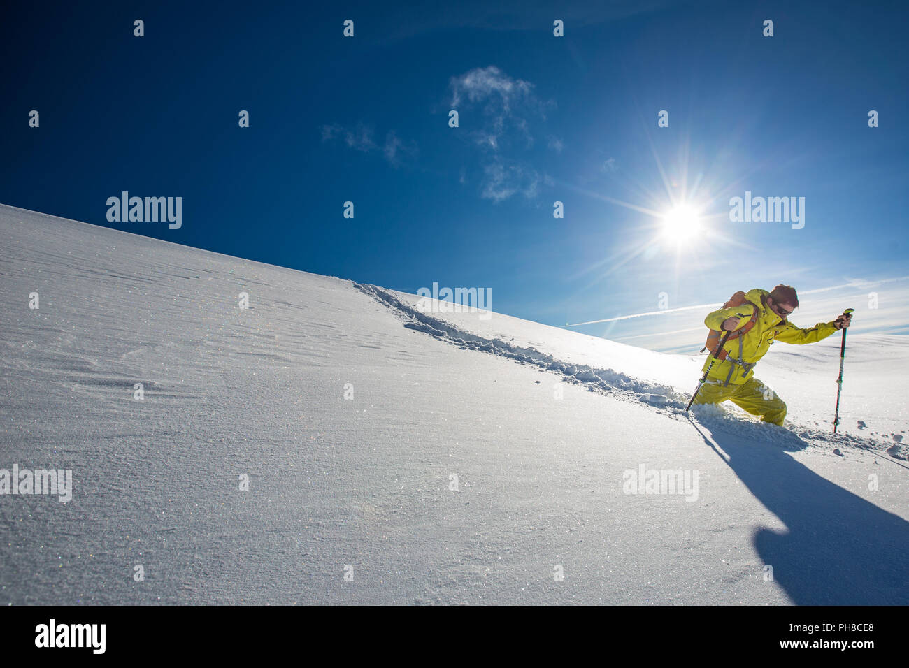 High altitude mountain explorer walking through deep snow in high ...
