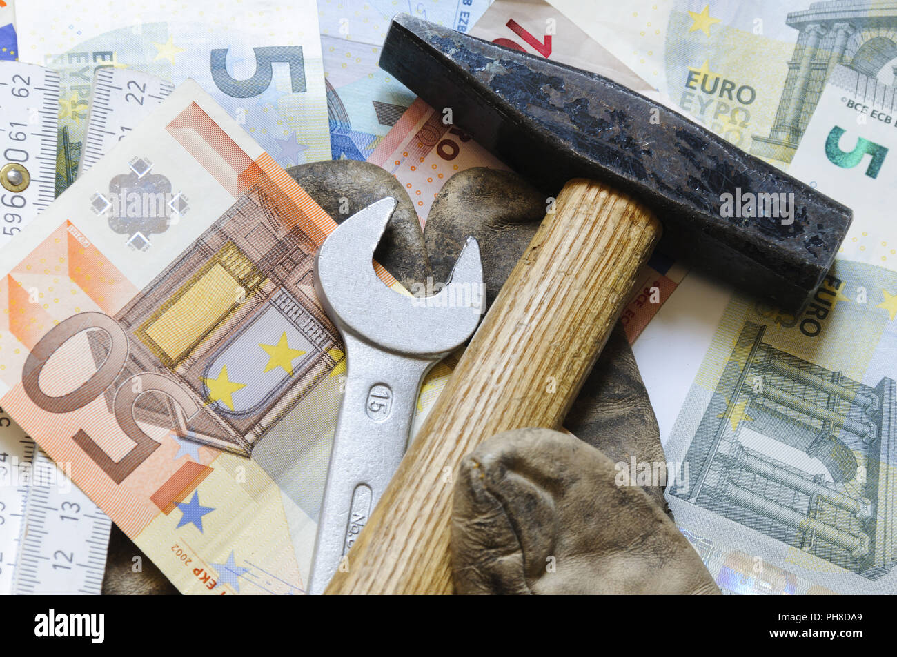 Tools with EURO banknotes Stock Photo - Alamy