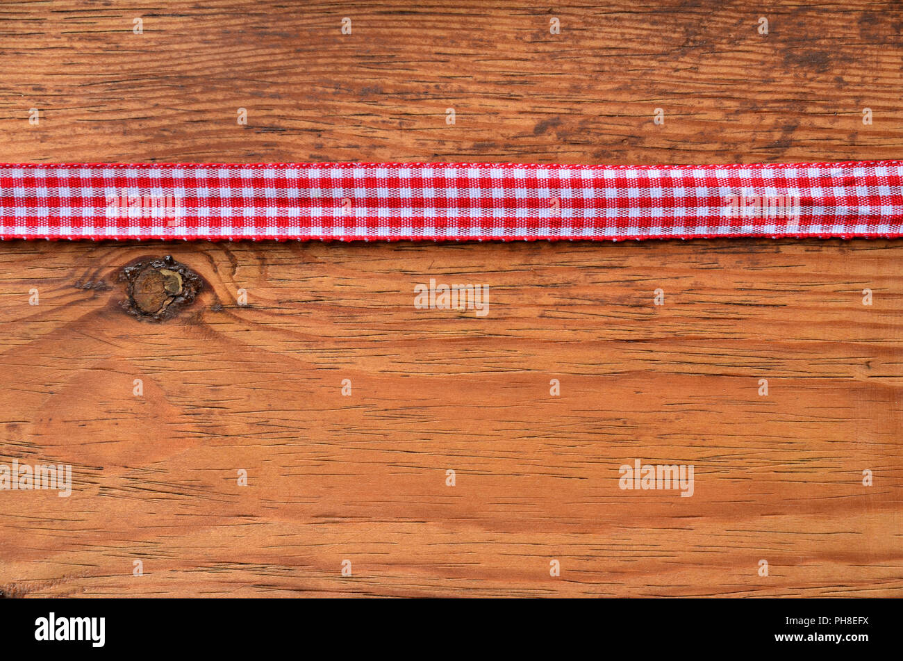 red checkered bow on wood background Stock Photo - Alamy