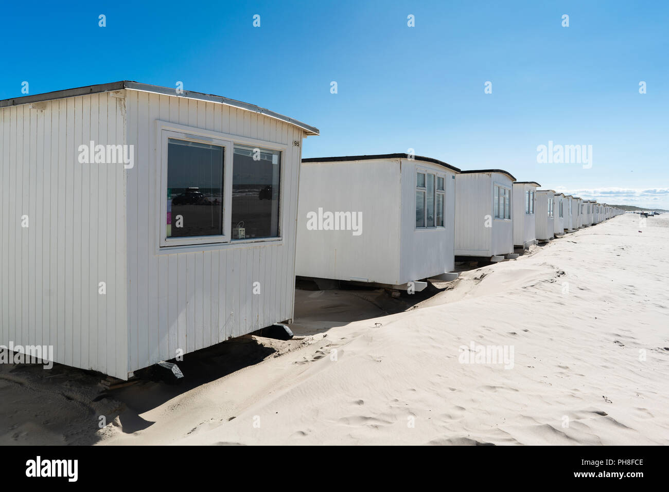 White beach huts at Løkken/ Lokken/ Loekken Beach, Denmark, in front of ...