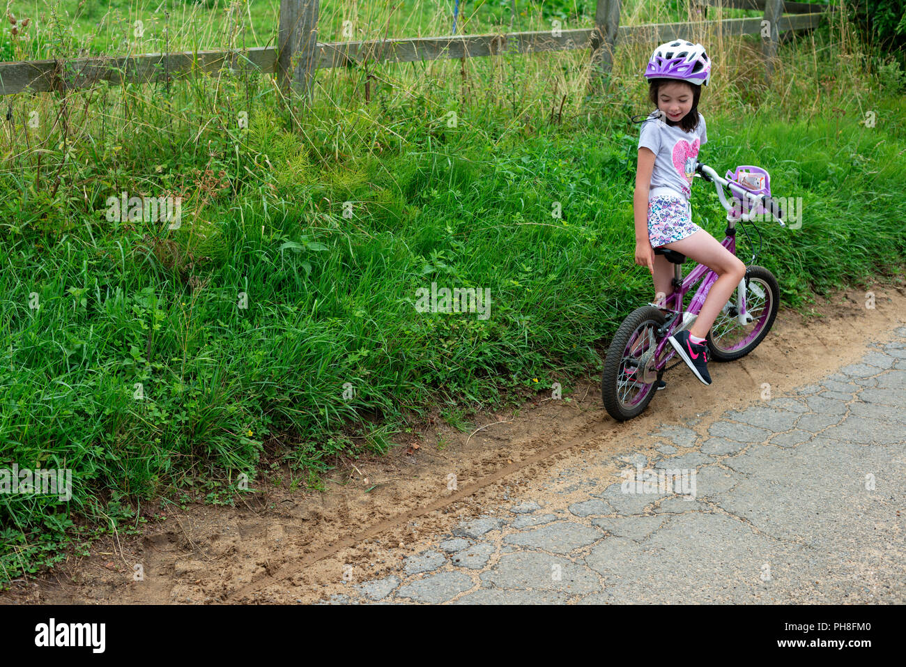 Young girl riding a cycle Stock Photo - Alamy