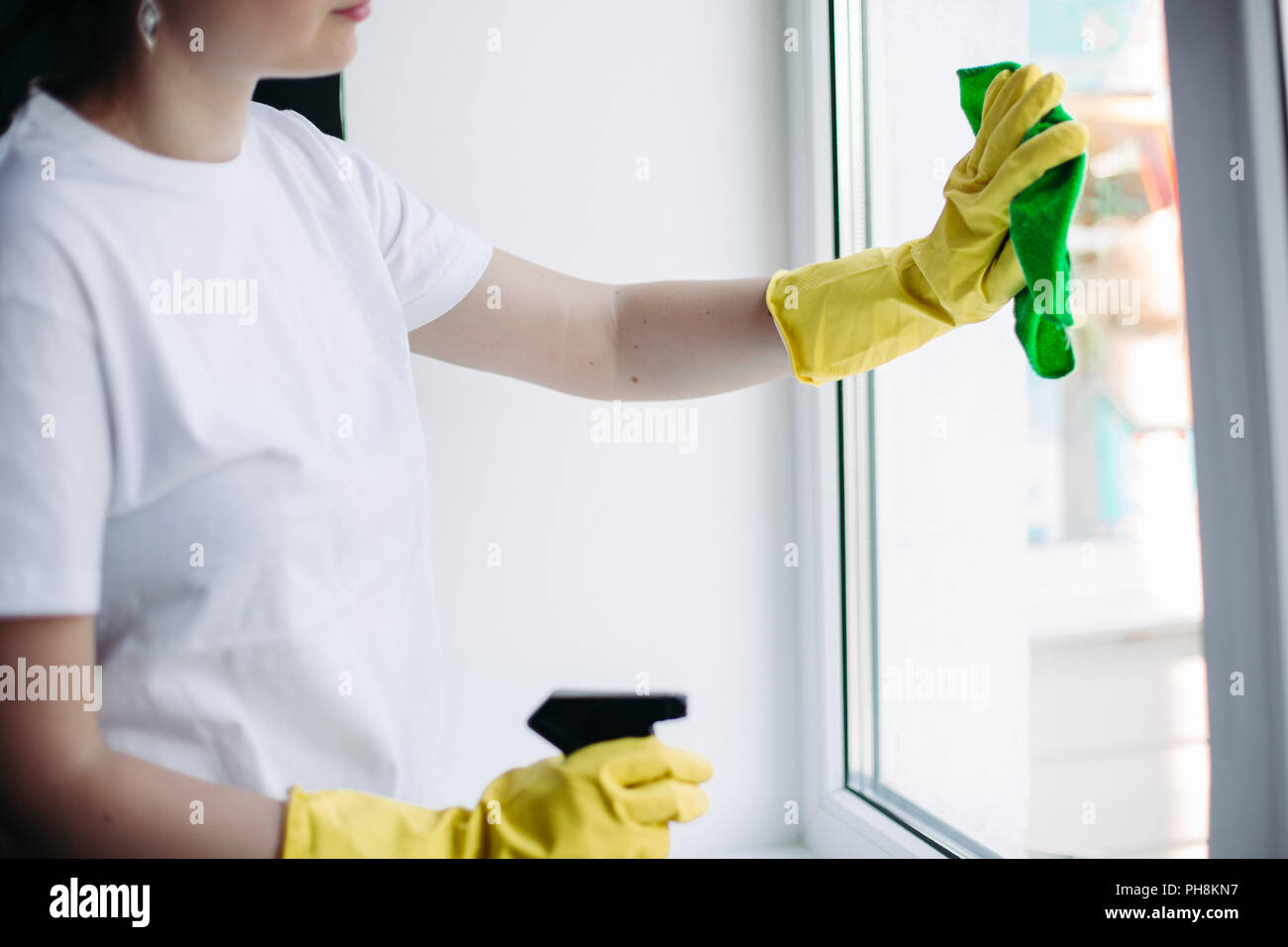 Crop of housewife cleaning dirty window. Concept of housework and ...