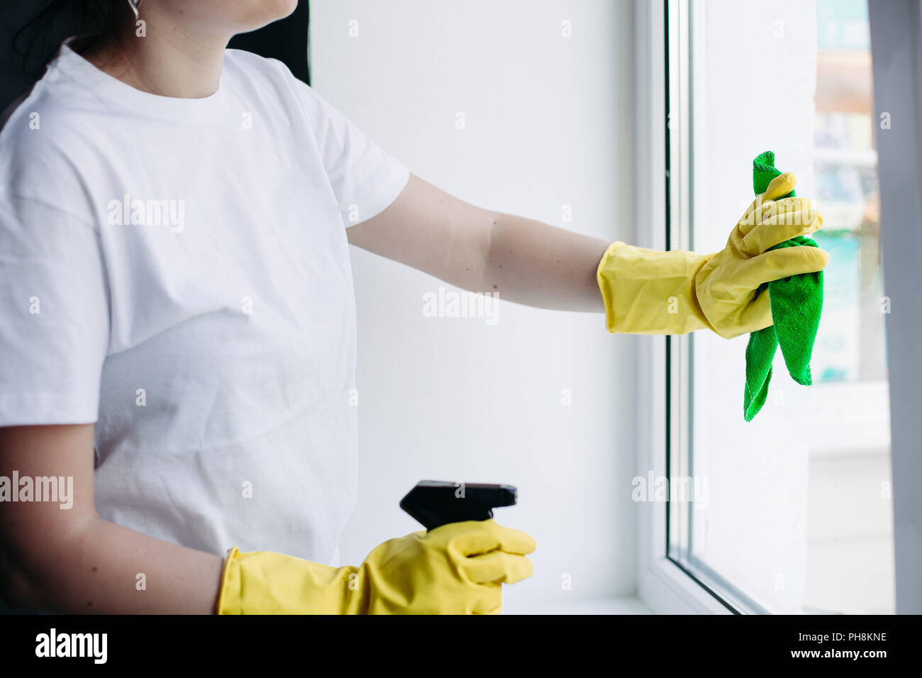 Crop of housewife cleaning dirty window. Concept of housework and ...