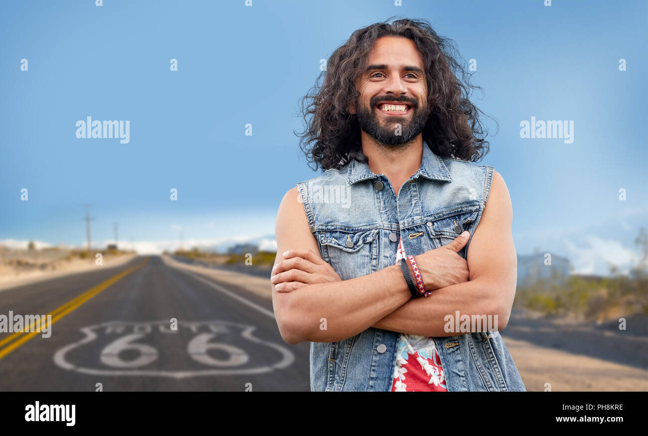 smiling hippie man in denim vest over us route 66 Stock Photo - Alamy