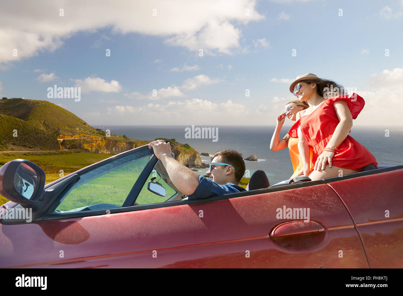friends driving in convertible car over big sur Stock Photo - Alamy
