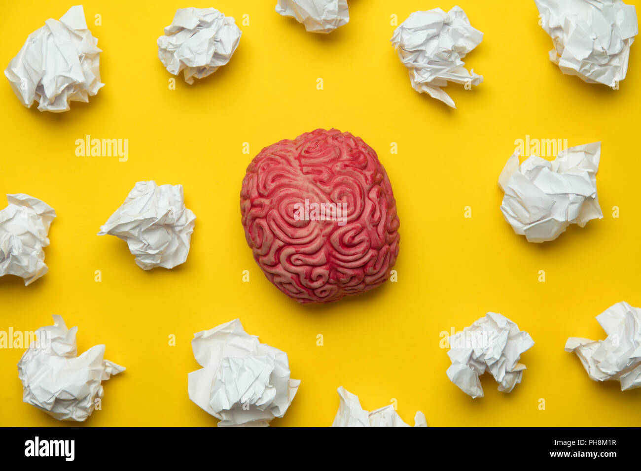Brainstorming ideas. Brain with crumpled paper on a yellow background ...