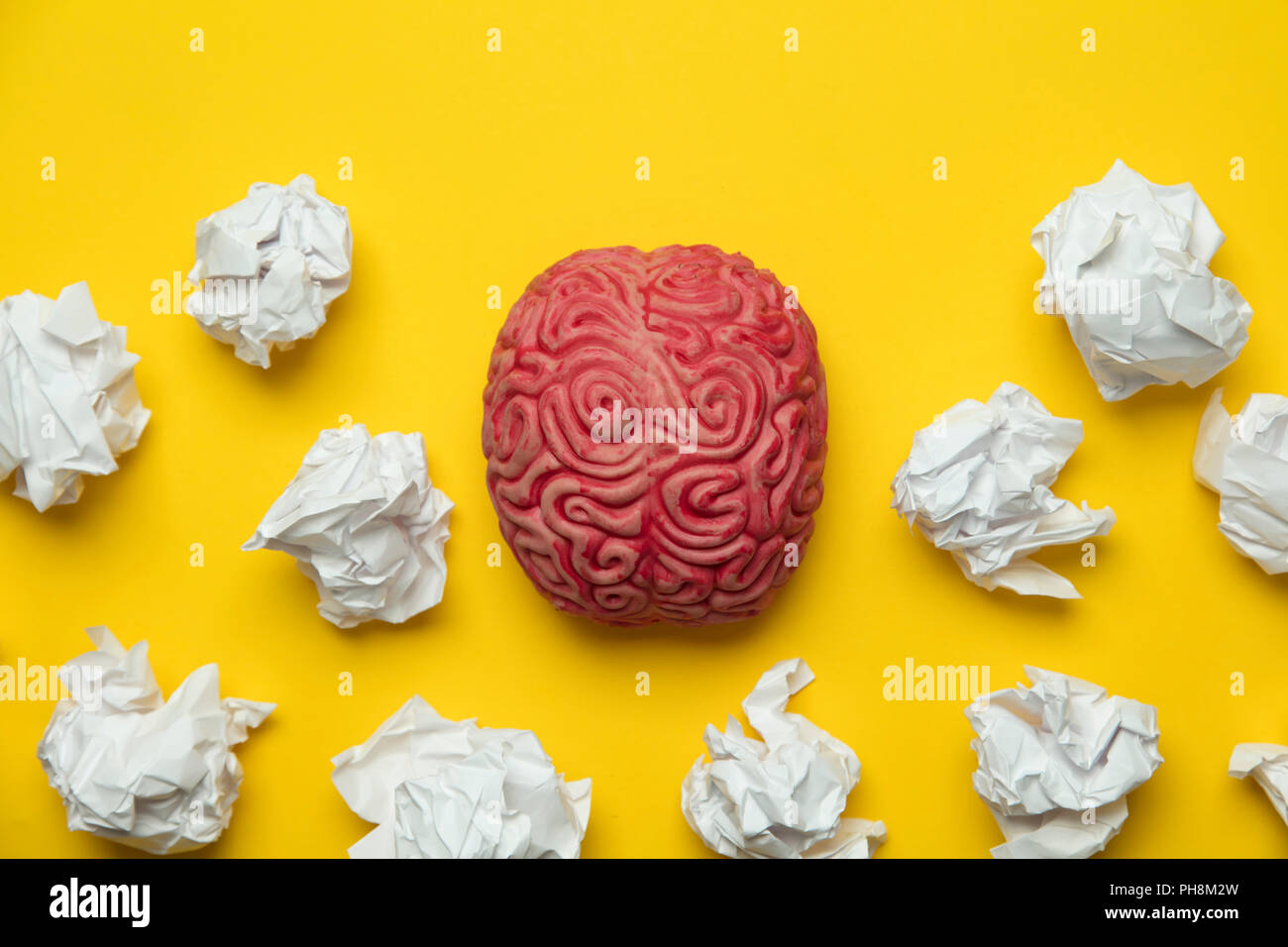 Brainstorming ideas. Brain with crumpled paper on a yellow background ...