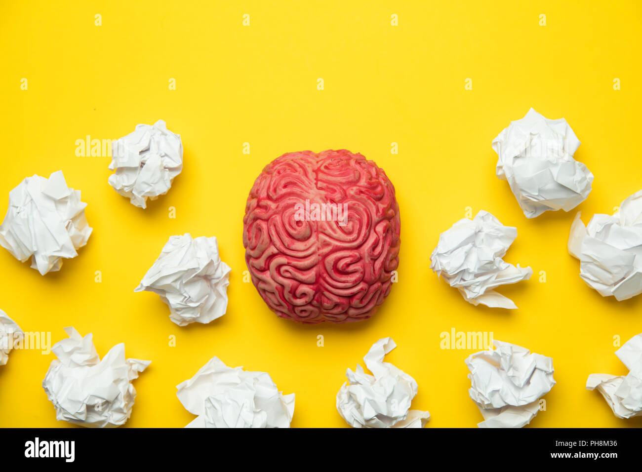 Brainstorming ideas. Brain with crumpled paper on a yellow background ...