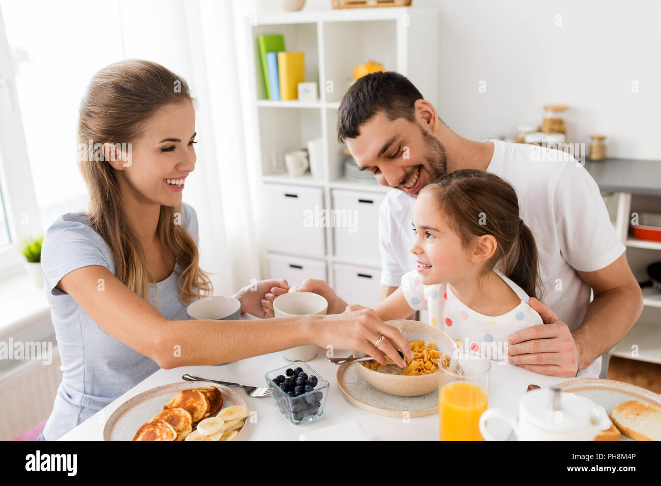 happy family having breakfast at home Stock Photo - Alamy