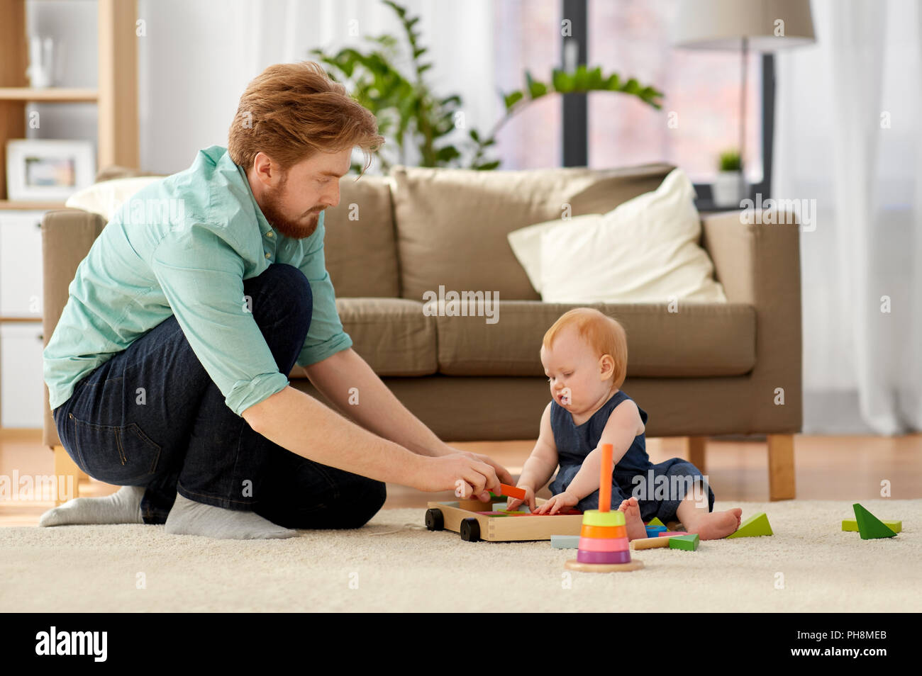 Father and infant playing with toy hi-res stock photography and images ...