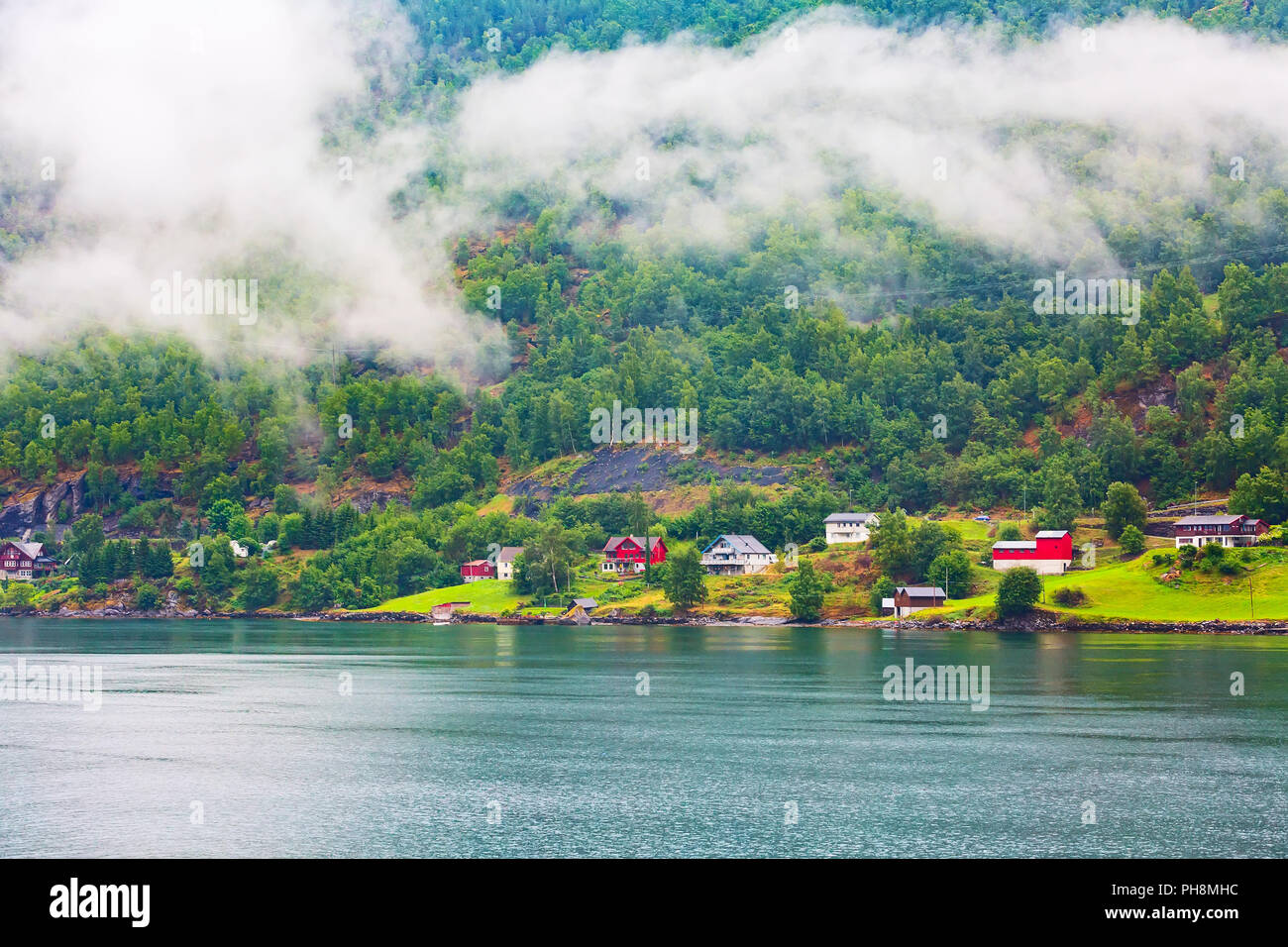 Norwegian fjord village in clouds and Sognefjord landscape near Flam ...
