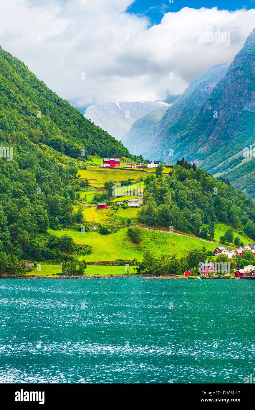 Norwegian village landscape with turquoise fjord water, mountains and ...