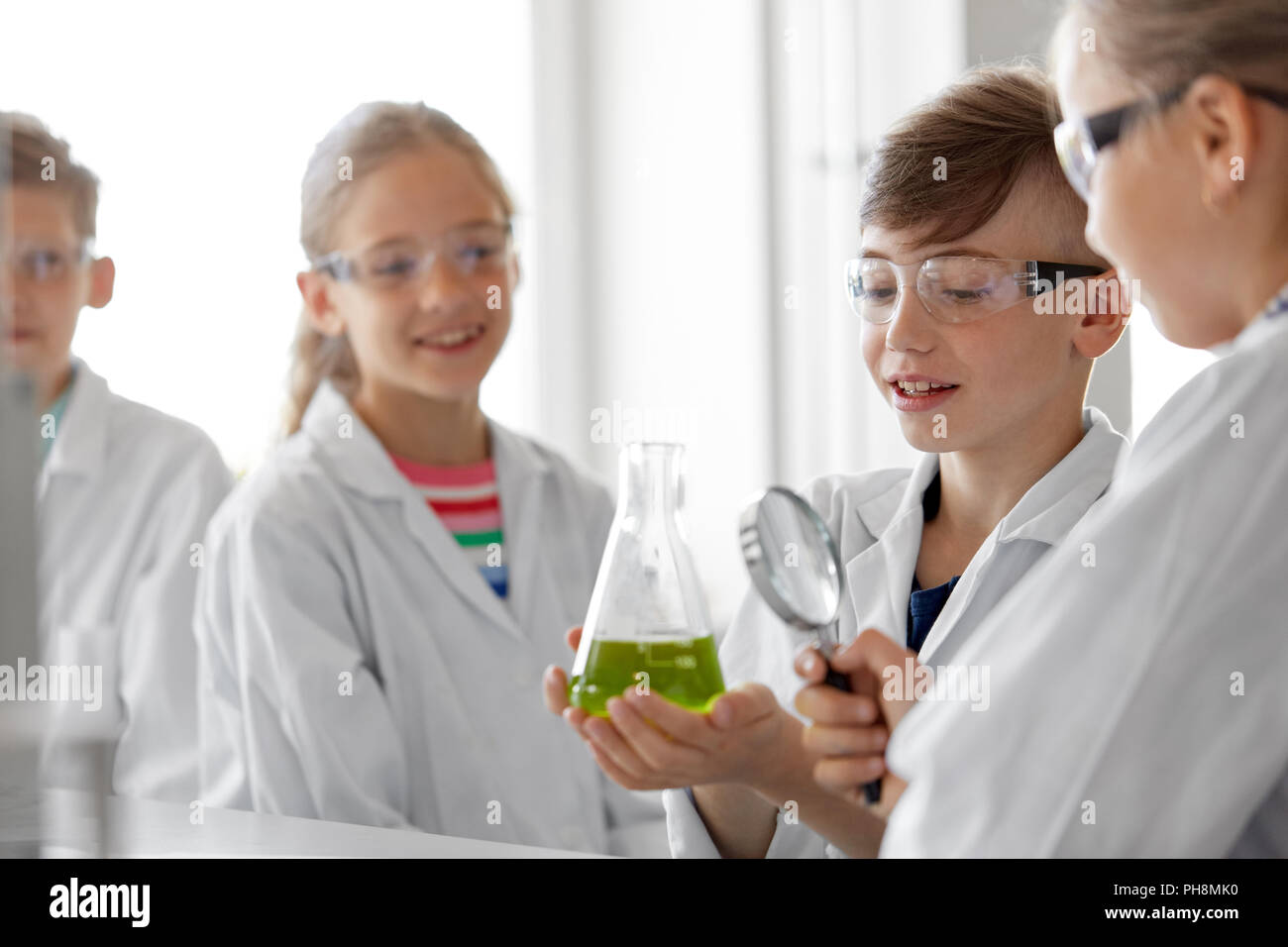 Teen boy girl science magnifying glass hi-res stock photography and ...