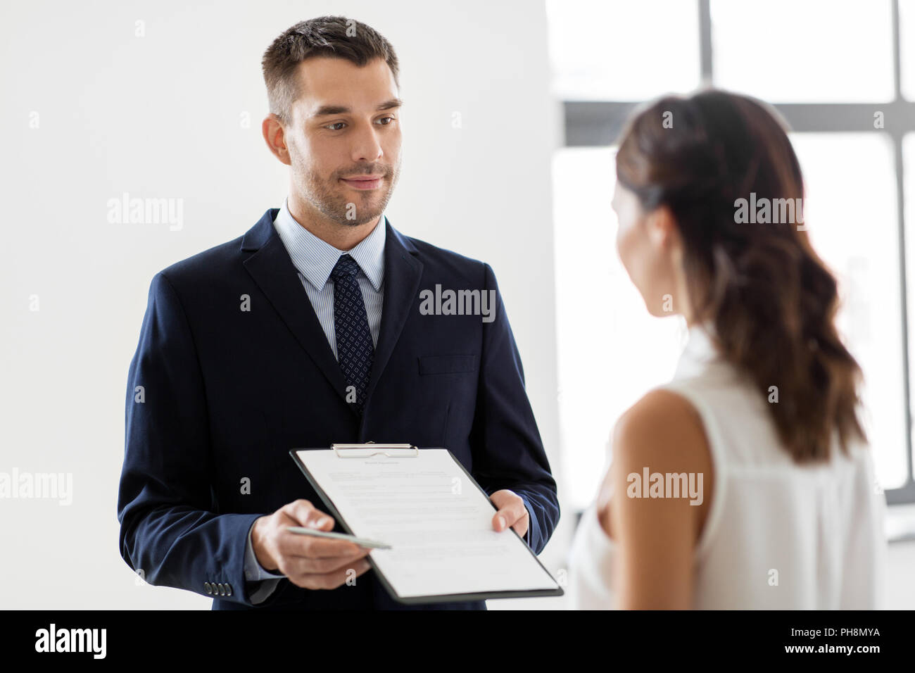 realtor showing contract document to customer Stock Photo - Alamy