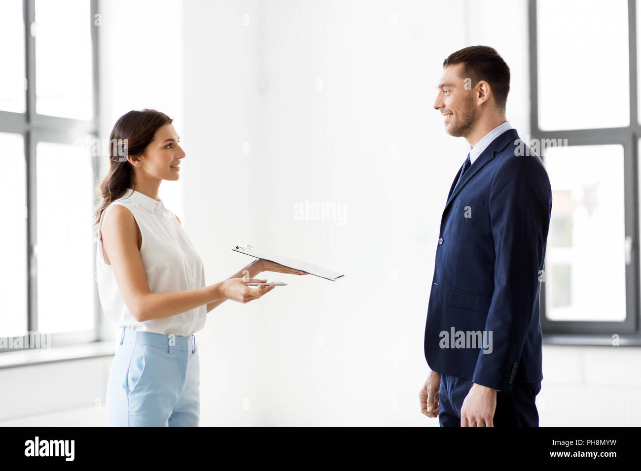 realtor showing contract document to customer Stock Photo - Alamy
