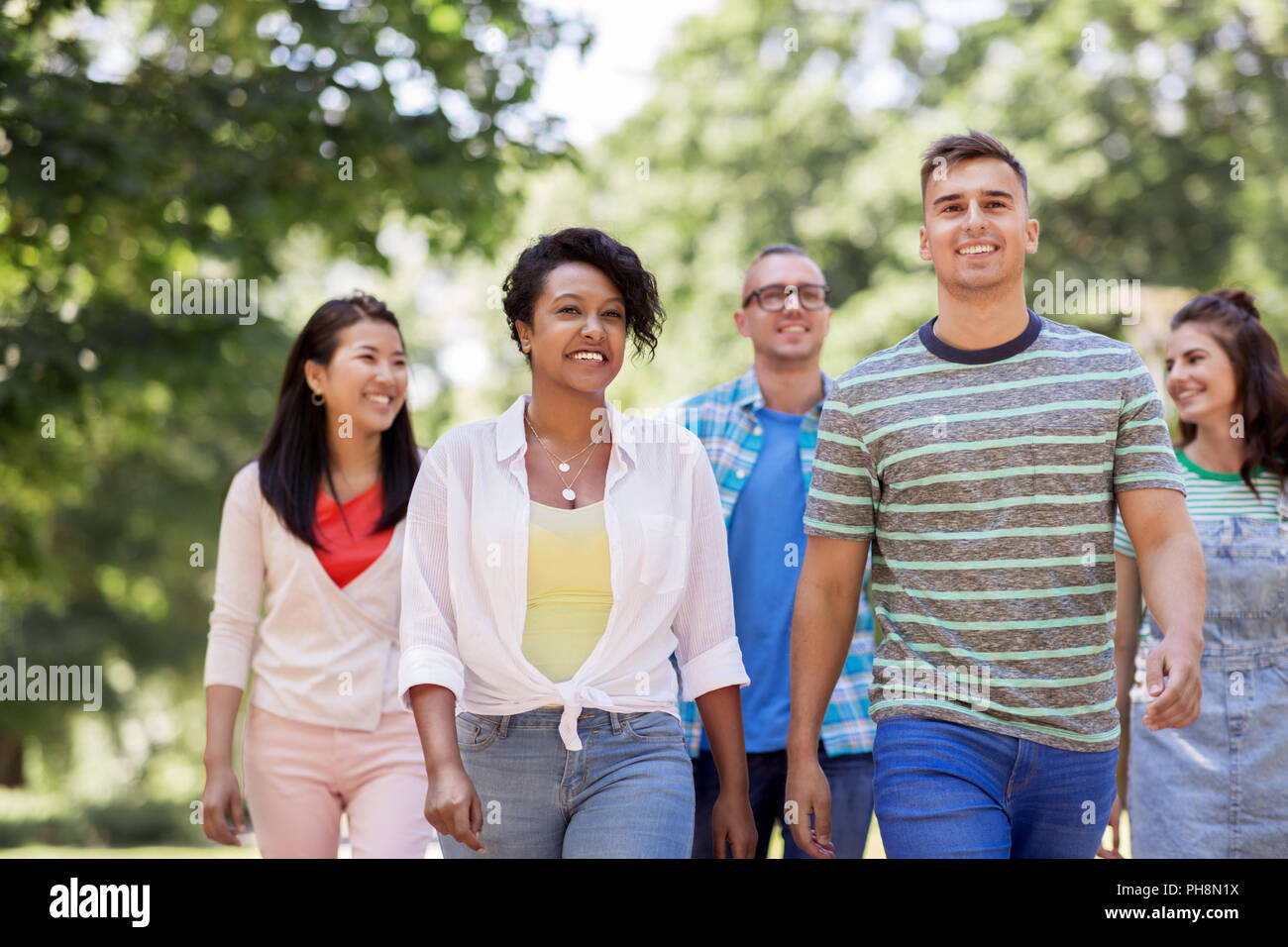 group of happy international friends in park Stock Photo - Alamy