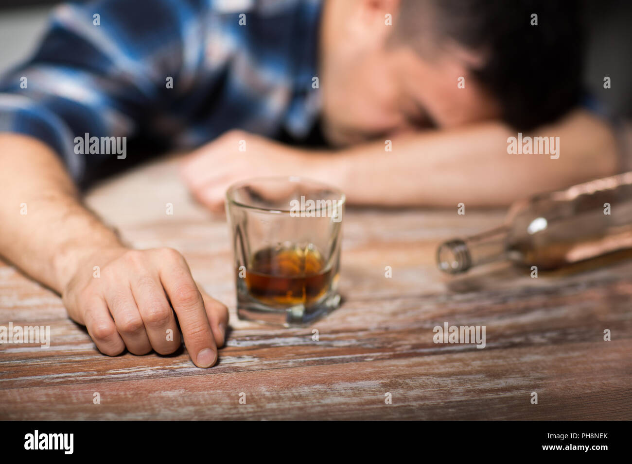 drunk man with glass of alcohol on table at night Stock Photo - Alamy