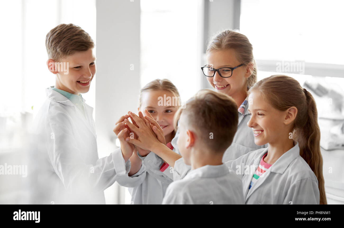 happy kids making high five at school laboratory Stock Photo - Alamy
