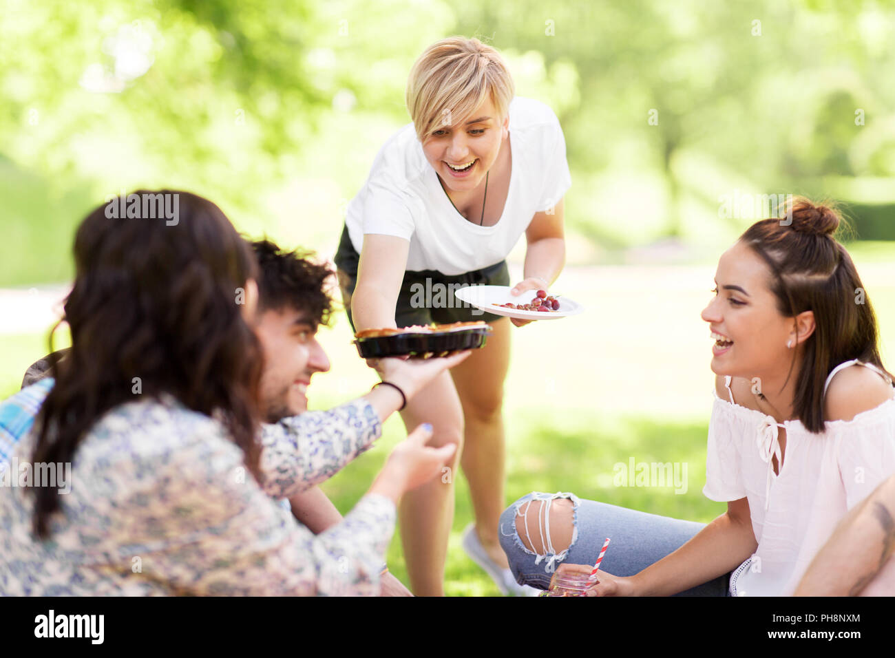 happy friends sharing pie at picnic in summer park Stock Photo - Alamy
