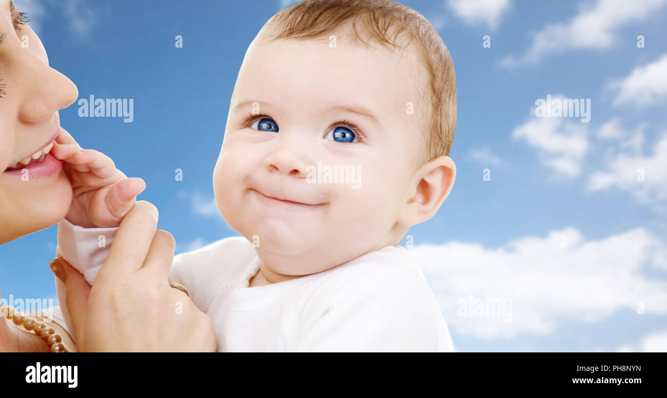 mother with baby over sky background Stock Photo - Alamy