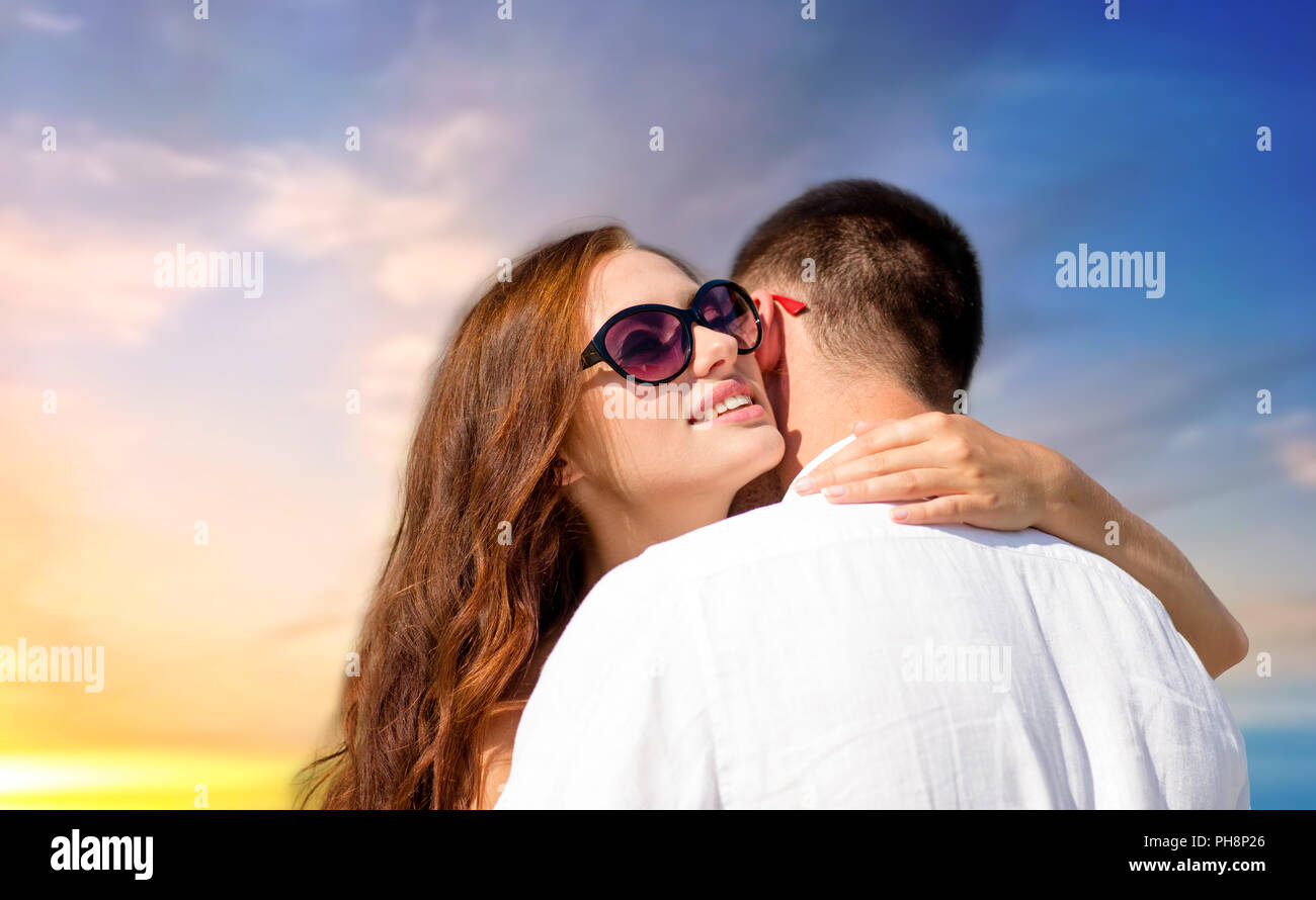 happy couple hugging over sunset sky background Stock Photo - Alamy