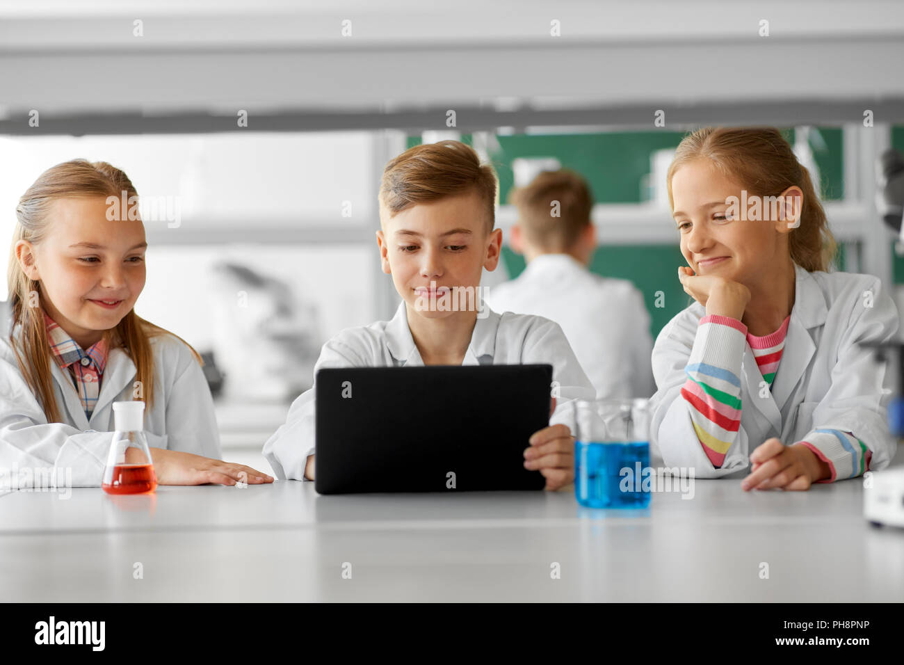 kids with tablet pc at school laboratory Stock Photo - Alamy