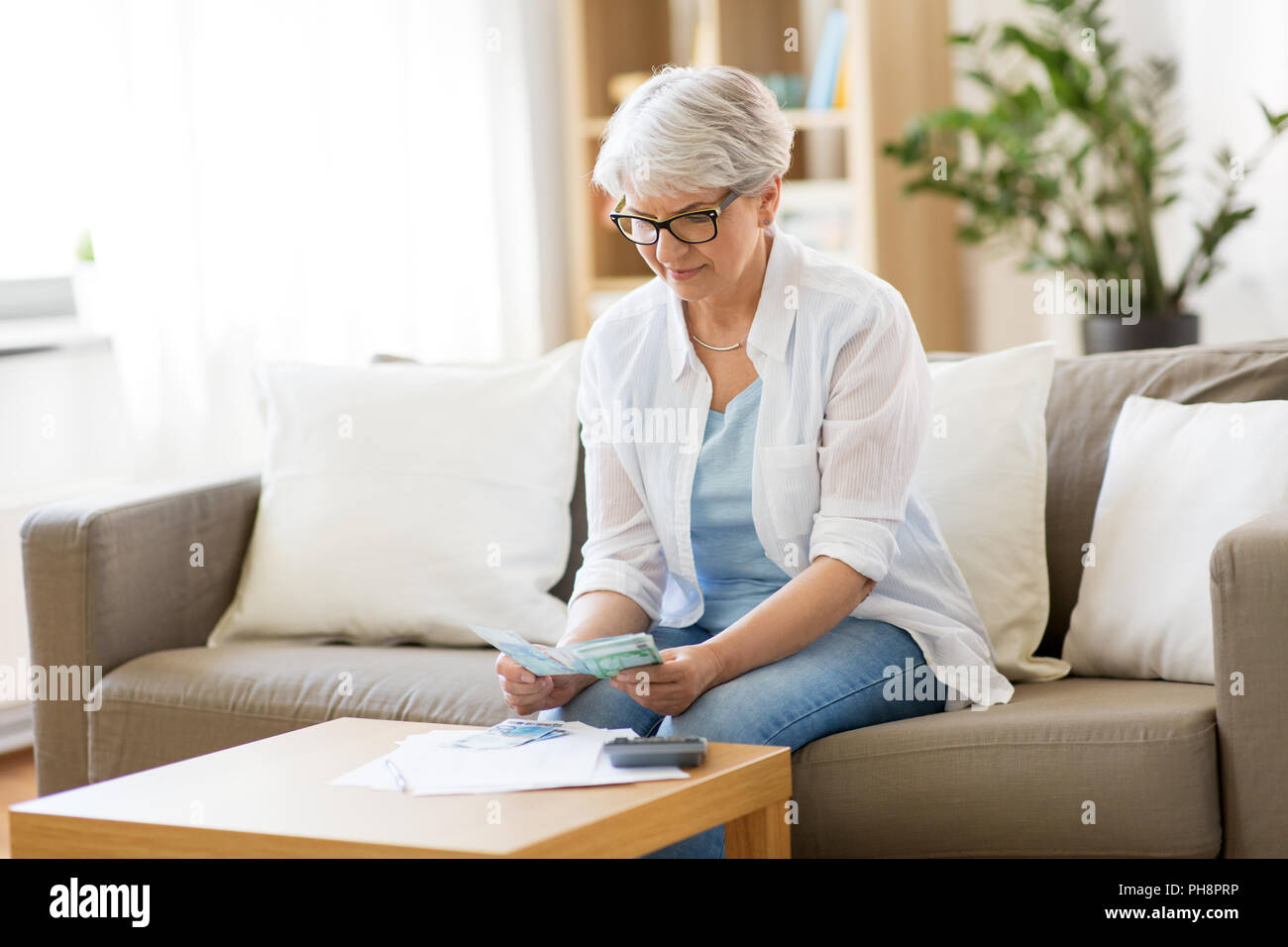 senior woman counting money at home Stock Photo - Alamy