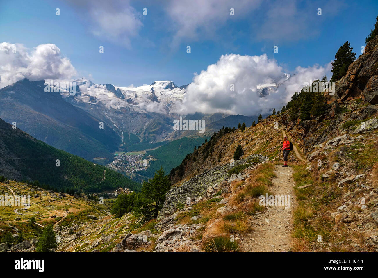 Single female hiker in red, on trail, Summer at Hohe Saas, Hohsaa ...