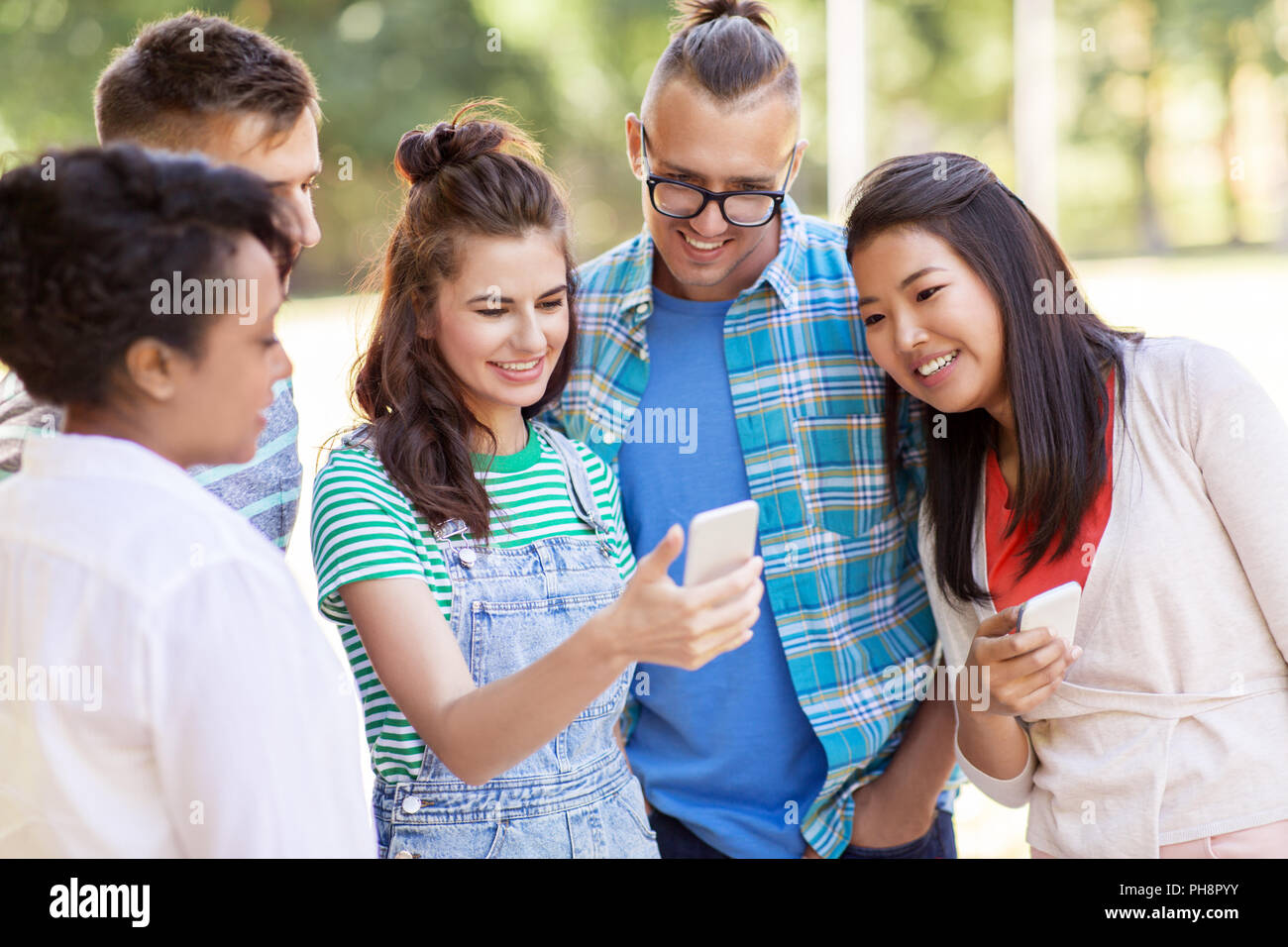 group of happy friends with smartphone outdoors Stock Photo - Alamy